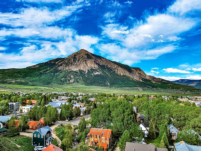 The town nestles at the mountain's feet like a colorful quilt. From above, Crested Butte's vibrant buildings pop against the landscape.