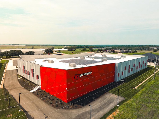 From above, K1 Speed's distinctive red exterior stands as a temple to indoor racing excellence. Where speed dreams come to life, rain or shine.
