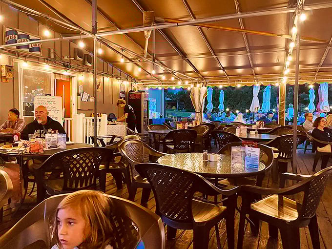 As day turns to evening, the covered deck transforms into a twinkling wonderland where seafood tastes even better under string lights.
