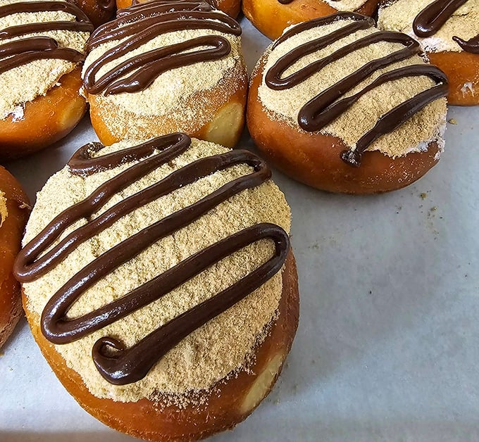 Banana split donuts: proving that ice cream isn't the only dessert that deserves this flavor combination. The chocolate drizzle is pure artistry.