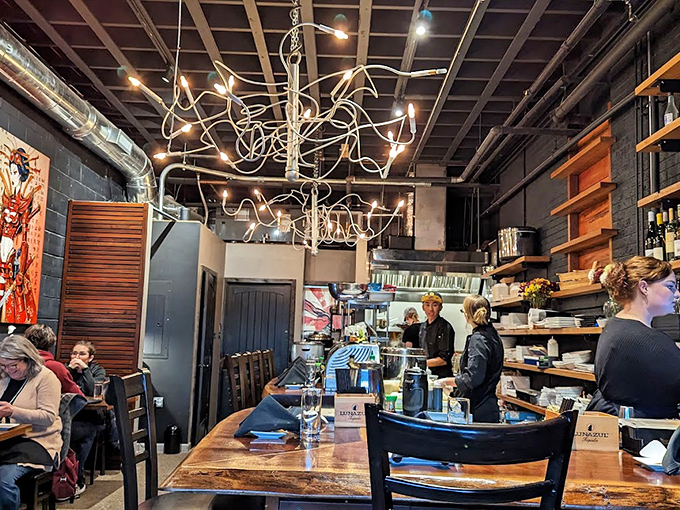 Bar Area: Industrial-chic meets maritime charm with that statement light fixture drawing your eye upward like a jellyfish in a James Cameron film.