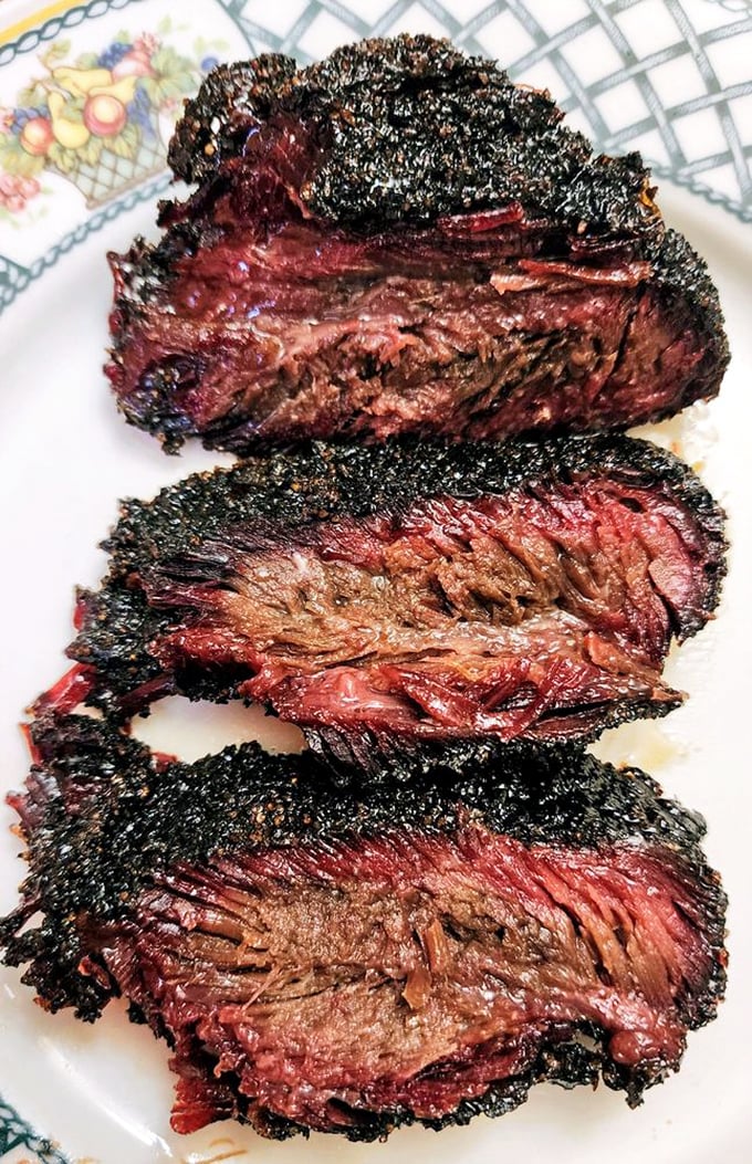 Slices of brisket with that characteristic black pepper crust and rosy interior that proves low and slow is the only way to go.