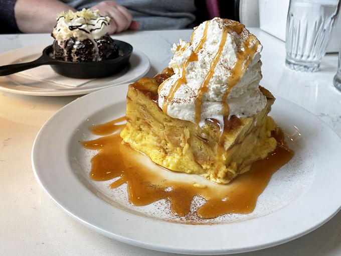 Bread pudding that defies gravity and restraint &ndash; topped with a cloud of whipped cream and drizzled with caramel that demands to be photographed, then devoured.