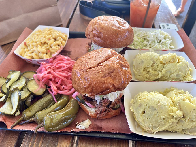 A sandwich that demands two hands and your full attention. Paired with mac and cheese, pickles, and slaw, it's a complete barbecue education.