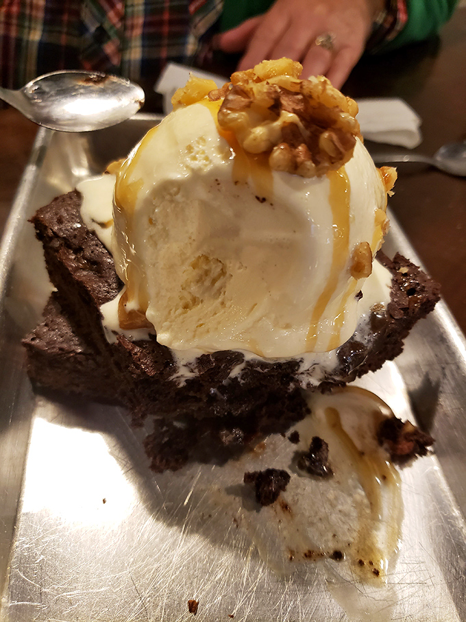 The perfect finale: warm brownie, cold ice cream, caramel drizzle, and candied walnuts. Proof that barbecue joints understand the importance of a sweet ending.