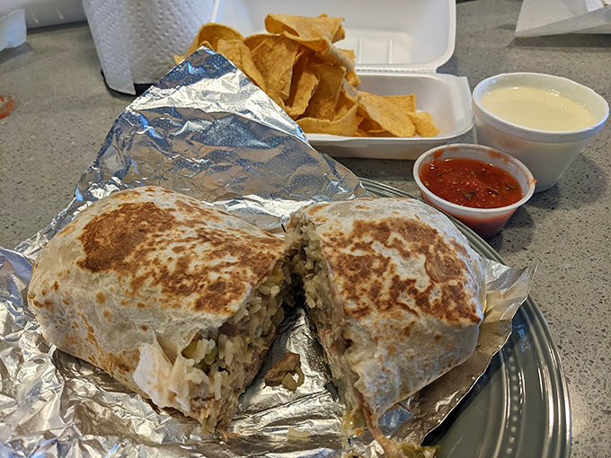 This burrito cross-section reveals the careful architecture within&mdash;layers of flavor that would make Frank Lloyd Wright weep with joy.