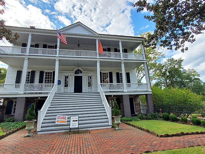 The Burgwin-Wright House welcomes visitors with its grand staircase and symmetrical charm, a white-columned time machine to colonial elegance.