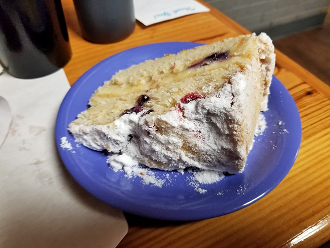 A slice of homemade pie dusted with powdered sugar that silently communicates, "Yes, you deserve this" after cleaning your plate.
