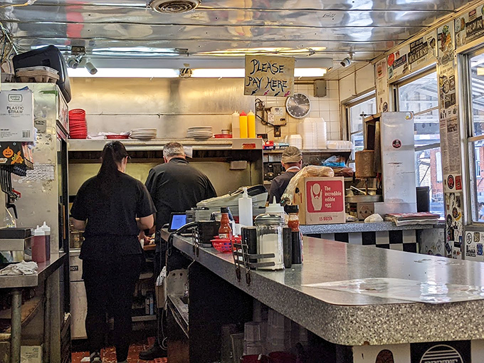 The counter where transactions are made, but the real currency is conversation between staff and the parade of humanity seeking sustenance.