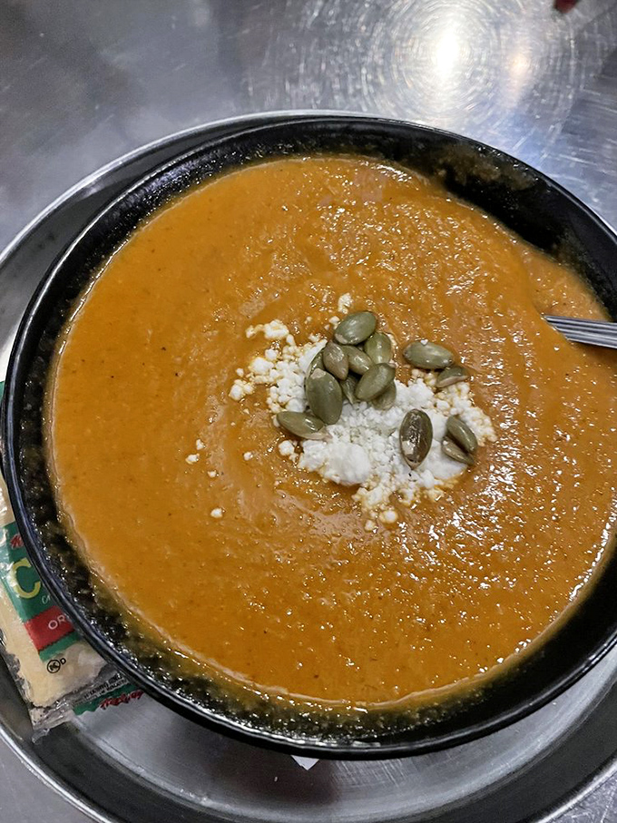 This isn't just soup&mdash;it's liquid comfort wearing a fancy hat of pumpkin seeds and cheese. Spoon-worthy evidence that vegetables can be decadent.