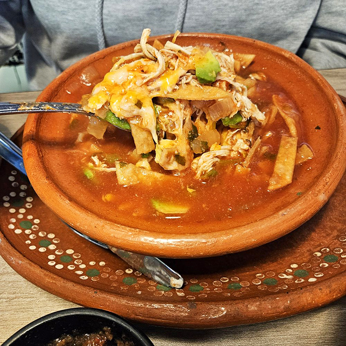 A hearty tortilla soup that combines crispy tortilla strips, tender chicken, and avocado in a broth so flavorful it could cure the common cold.