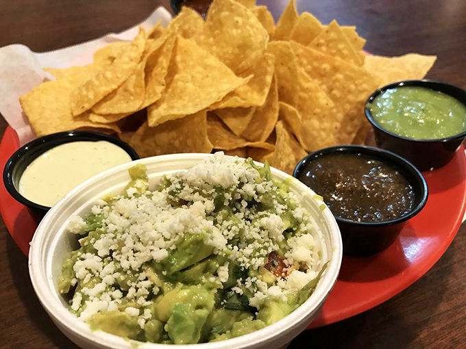 Guacamole sprinkled with cotija cheese alongside a trio of salsas and perfectly crisp chips. This isn't just an appetizer—it's the opening act of a culinary concert.