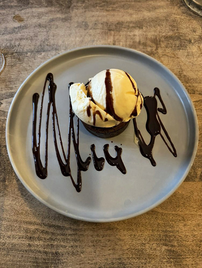 A chocolate dessert that's clearly been to art school. The ice cream is melting just enough to create that perfect warm-meets-cold magic moment.