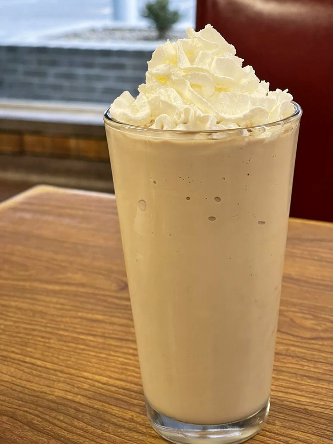 The chocolate malt arrives like a creamy tower of nostalgia, topped with whipped cream that doesn't come from a can. Sip slowly&mdash;memories are being made.