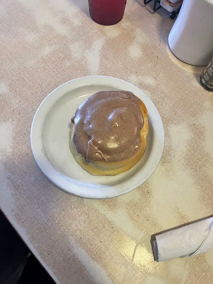 Behold the cinnamon roll—a spiral-bound dissertation on why simple pleasures still matter. The glaze isn't just a topping; it's a commitment to excellence.
