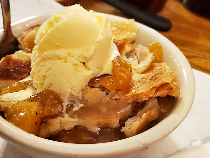 The perfect finale: warm fruit cobbler crowned with melting ice cream that makes you wonder if you actually do have room for dessert.