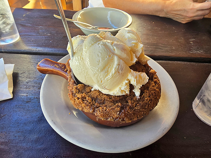 This cobbler isn't just dessert, it's a warm hug topped with vanilla ice cream that's melting with excitement to meet its cinnamon-spiced friend below.