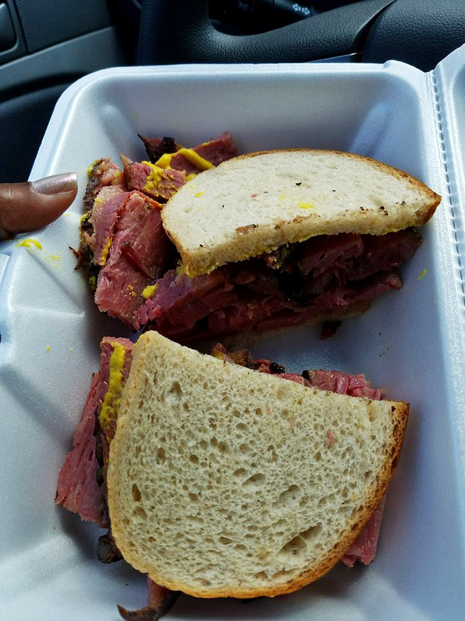 Corned beef stacked higher than a Midwest snowdrift. That mustard pop against the pink meat is visual jazz for sandwich lovers.