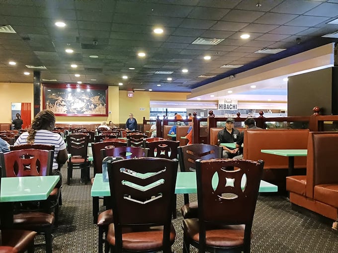 The dining room: battlefield staging area for serious eaters. Those green tables have witnessed countless buffet triumphs and defeats.