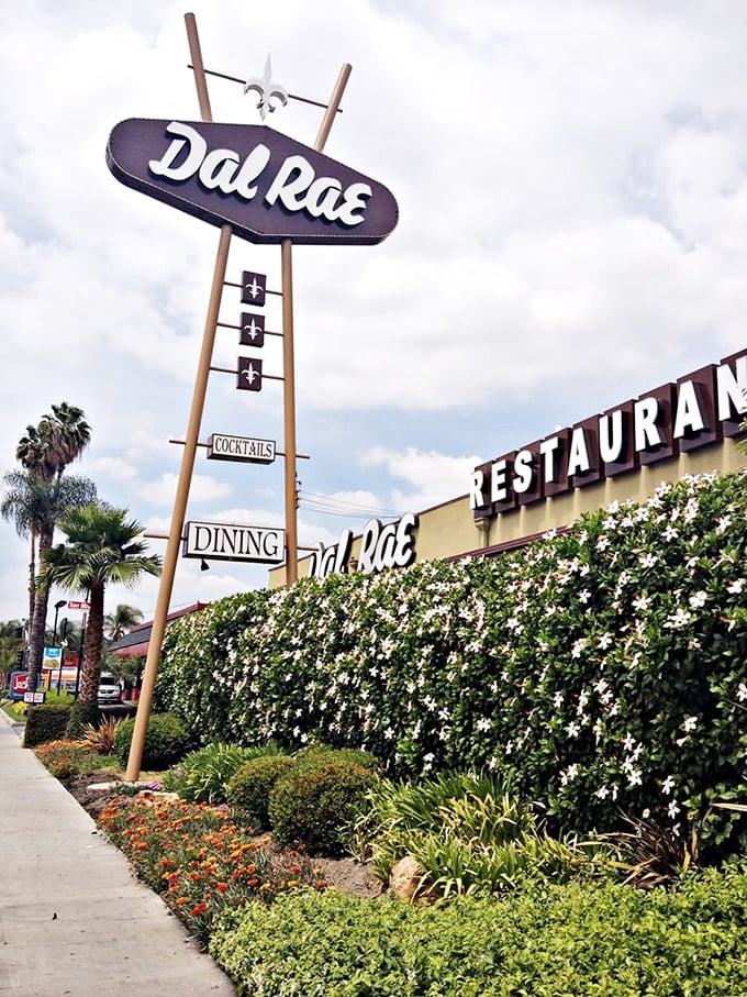 The Dal Rae's exterior in daylight reveals its classic roadside charm. That sign has been pointing the way to memorable meals longer than most restaurants have existed.