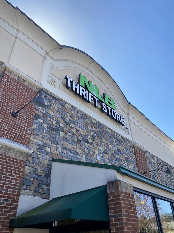 Under clear blue Georgia skies, the NLB Thrift Store sign beckons bargain hunters and vintage enthusiasts alike. Adventure awaits just beyond those doors.