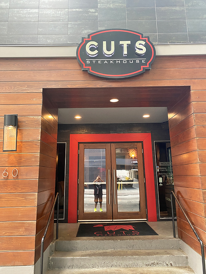 The entrance isn't just a doorway&mdash;it's an invitation. That red pop of color against warm wood signals the memorable experience that awaits.