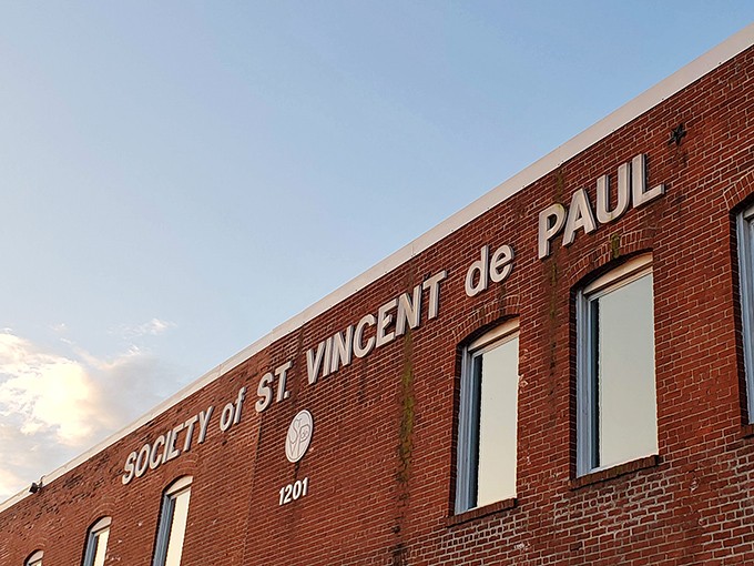 The Society of St. Vincent de Paul sign reminds shoppers that their treasure hunting supports a mission greater than finding the perfect vintage lamp.