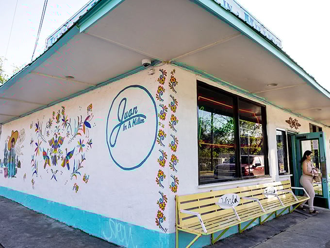 Folk art flowers bloom across the exterior walls, creating a fiesta before you even step inside. This corner of Austin promises flavor in every form.