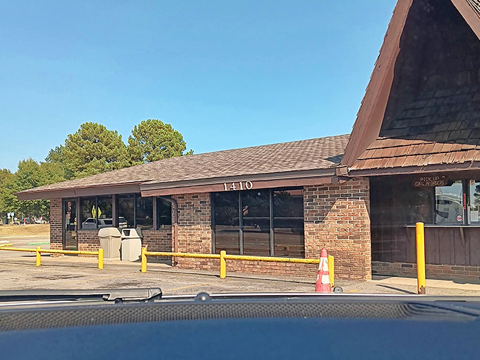 The A-frame roof and brick exterior have welcomed generations of burger enthusiasts. Some buildings house treasures; this one grills them.