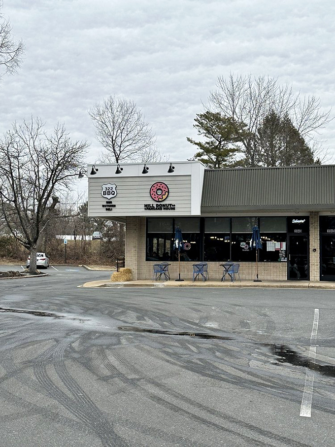Winter can't dampen the warm welcome of Hill Donut Co, where the pink sign promises sweet salvation regardless of season.