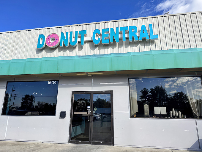 Morning sunshine highlights the cheerful signage, with that pink donut "O" practically winking at passersby. Resistance is futile; donuts await inside.
