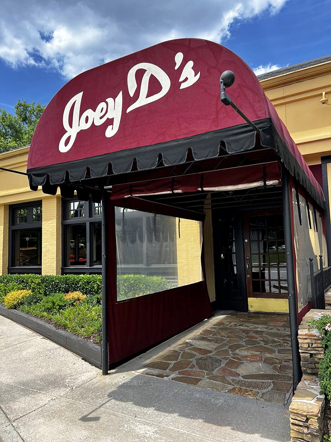The entrance's burgundy awning creates that perfect moment of anticipation&mdash;like the pause before the first bite of something wonderful.