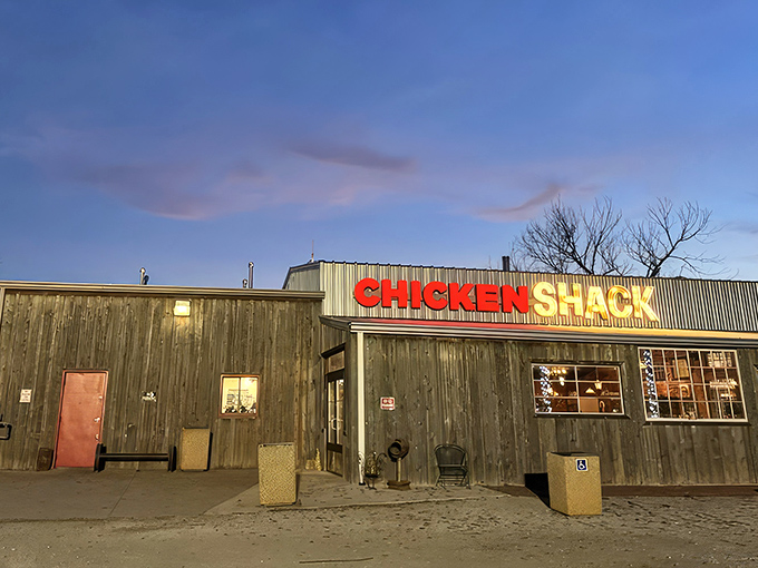 As dusk settles over Arcadia, the Chicken Shack's illuminated sign serves as a beacon for hungry travelers seeking fried chicken salvation.