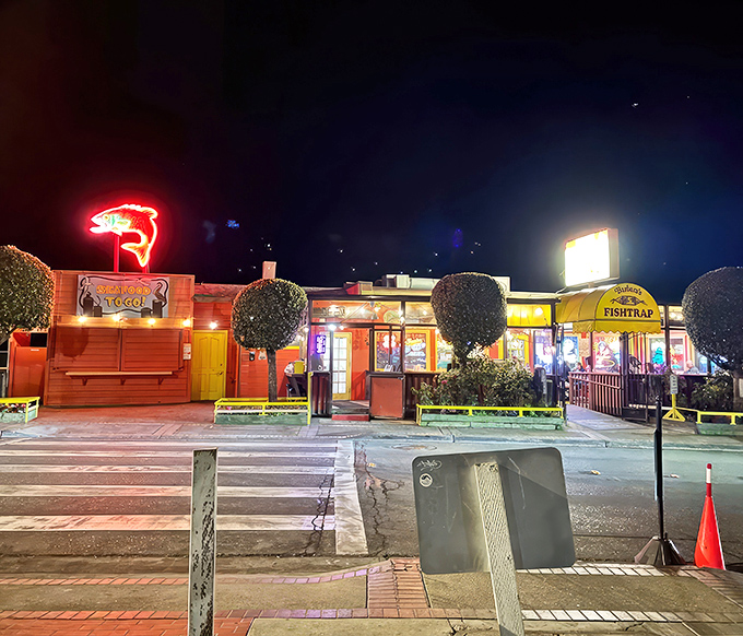 By night, Barbara's Fishtrap glows like a beacon for hungry travelers. The neon fish sign practically whispers, "Yes, we're still serving those crab cakes you dream about."