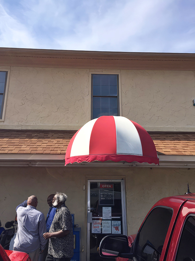 That red and white awning isn't just decorative&mdash;it's a beacon calling hungry travelers to authentic Southern hospitality.