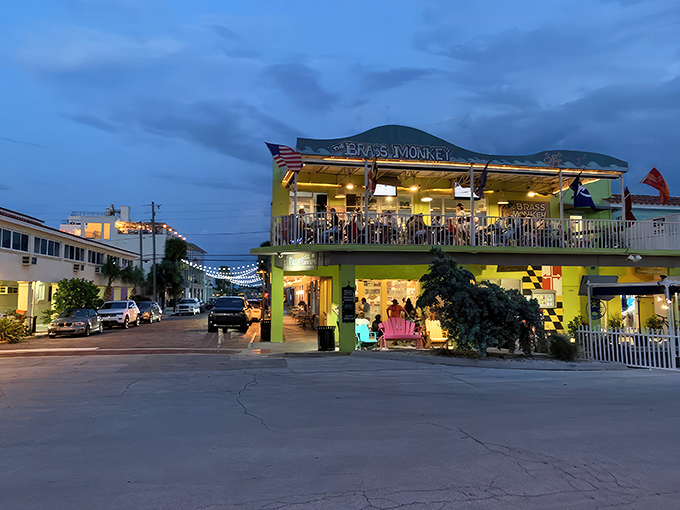 As evening falls, the Brass Monkey glows like a yellow lantern, beckoning hungry travelers with the promise of seafood salvation.
