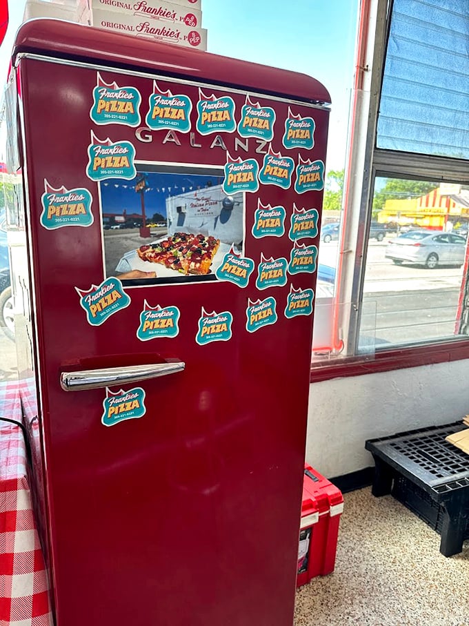 A fridge covered in logo stickers&mdash;the pizza equivalent of a well-stamped passport. Each one represents a delicious memory.