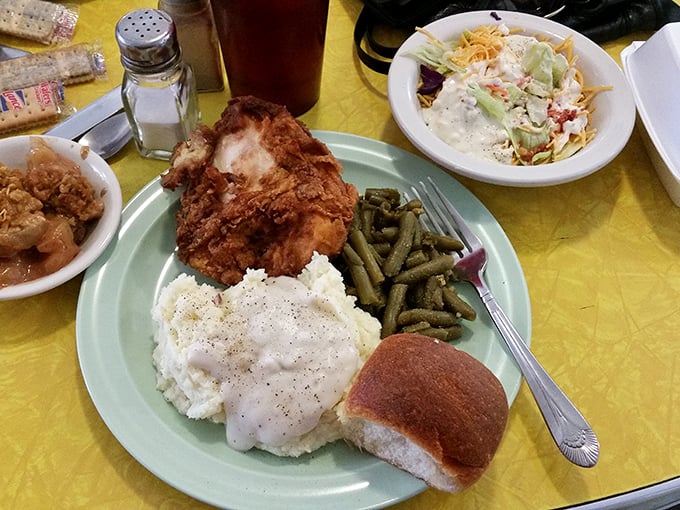 The holy trinity of comfort food: crispy fried chicken, creamy mashed potatoes with gravy, and green beans &ndash; served with a side of nostalgia.