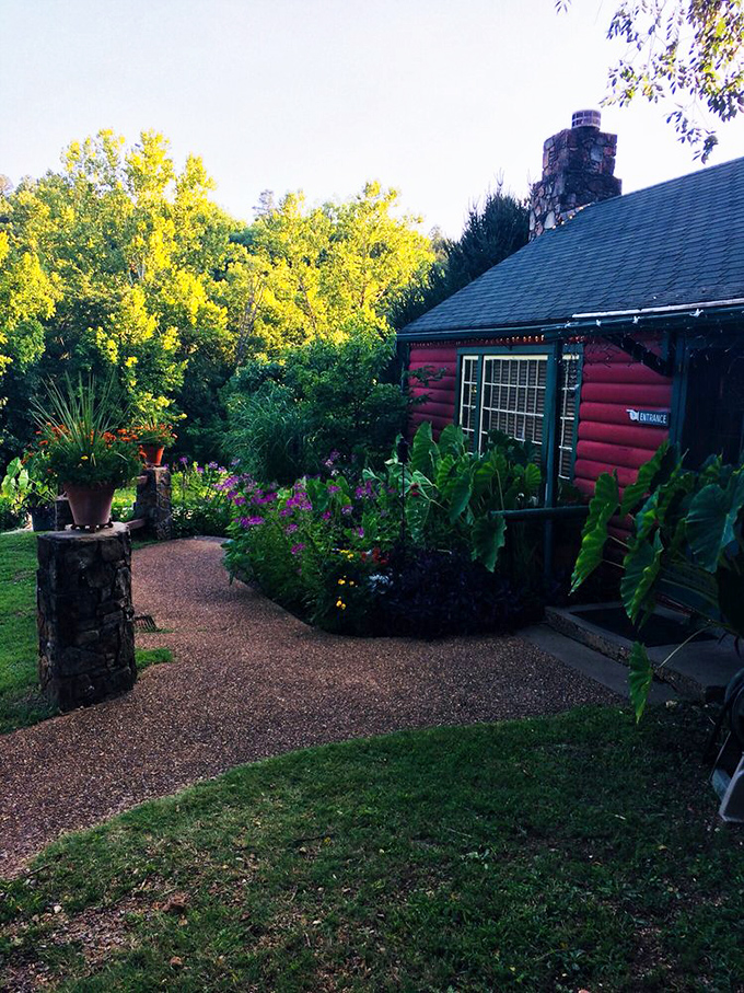 Gardens frame the entrance with seasonal blooms and lush foliage—nature's own welcome committee for hungry travelers seeking Ozark flavors.
