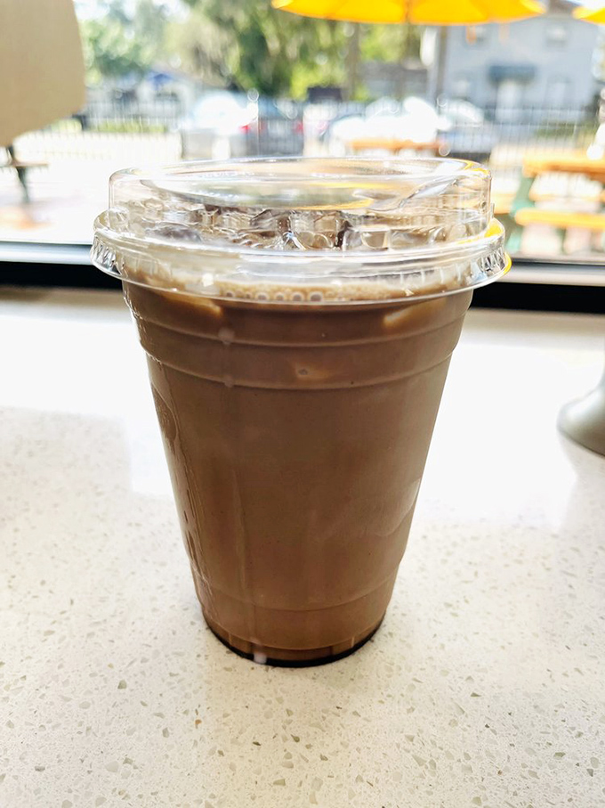 An iced coffee with a view of those yellow umbrellas—the perfect companion for contemplating which doughnut deserves your attention next.