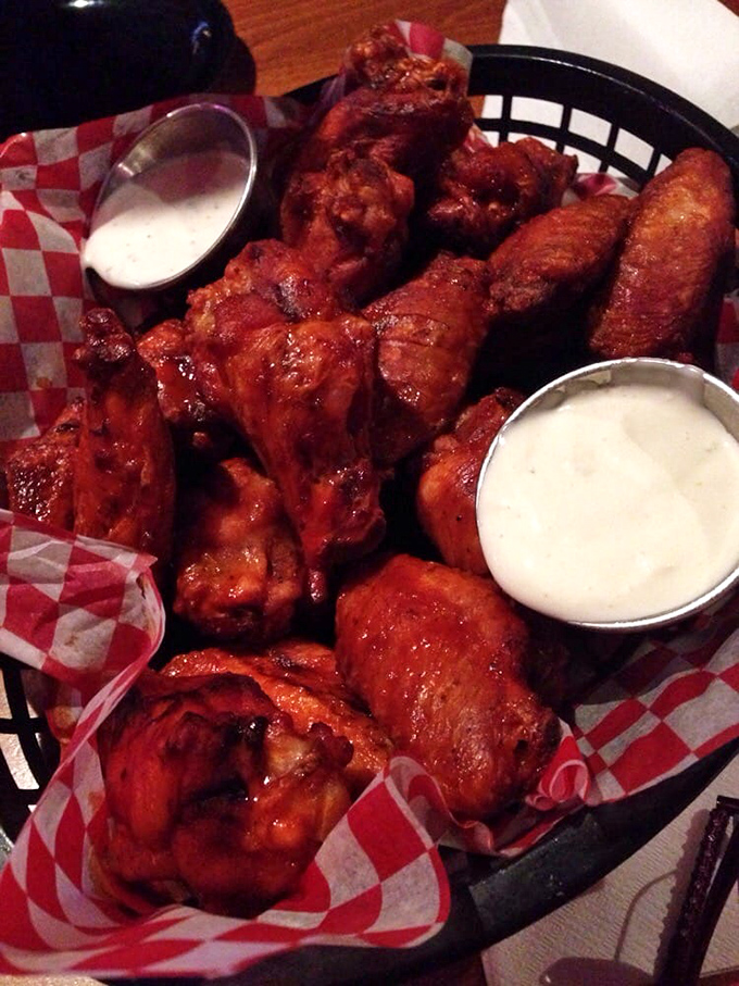 These wings aren't just spicy&mdash;they're having more fun than you are, bathing in sauce with their friends in a red-checkered hot tub.