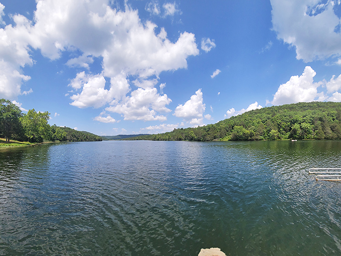 Lake Leatherwood stretches like a mirror between forested hills, offering a serene counterpoint to the bustling streets of town just minutes away.