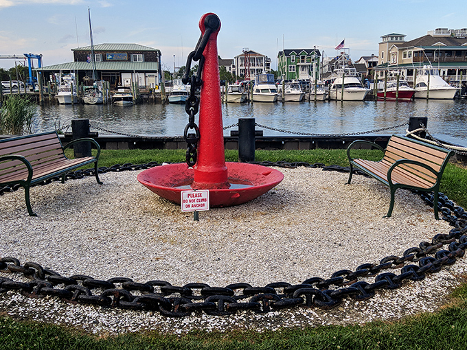 A bright red anchor rests ceremoniously at Canalfront Park, where benches invite visitors to watch boats glide past while contemplating centuries of maritime history.