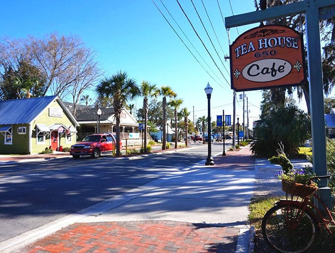 The Tea House Caf&eacute;'s cheerful sign marks one of Crystal River's beloved eateries. Yellow cottages and palm trees create the quintessential Old Florida streetscape that big coastal cities can only dream about.