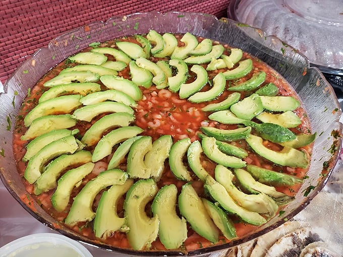 A festival of avocado slices arranged like a green sunburst atop what appears to be a seafood dish&mdash;visual proof that Mexicans were food stylists before it was cool.
