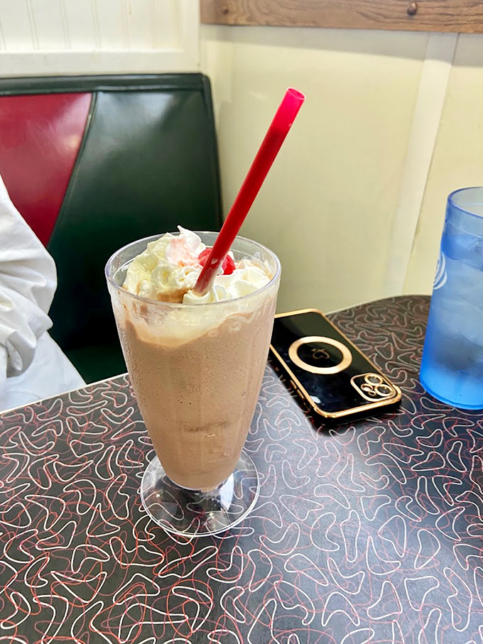 A milkshake so thick it defies gravity and common sense. The straw stands at attention, knowing full well it's more for show than function.