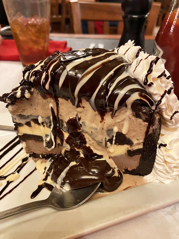 This isn't just dessert; it's architecture with a chocolate roof. A mud pie so decadent it requires a moment of silence before diving in.