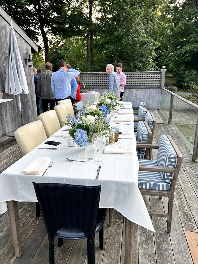 Outdoor dining at its finest: white tablecloths, hydrangeas, and the promise of a meal worth remembering under Connecticut's summer sky.