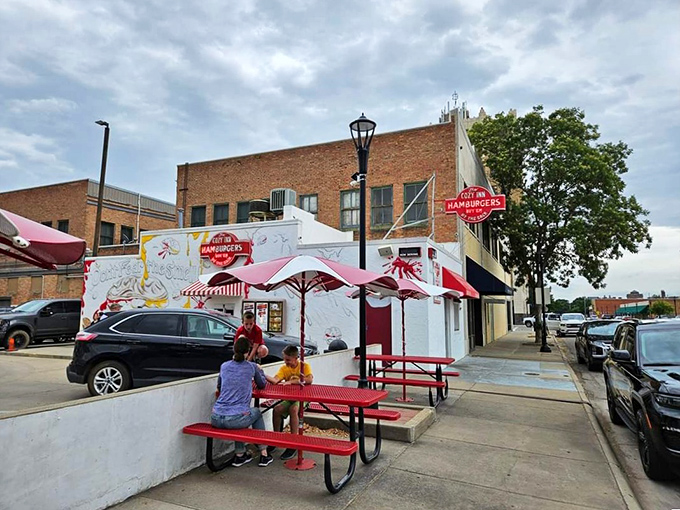 Outdoor seating: where Cozy Inn pilgrims gather to worship at the altar of the slider. These red tables have heard countless "mmms" of satisfaction.