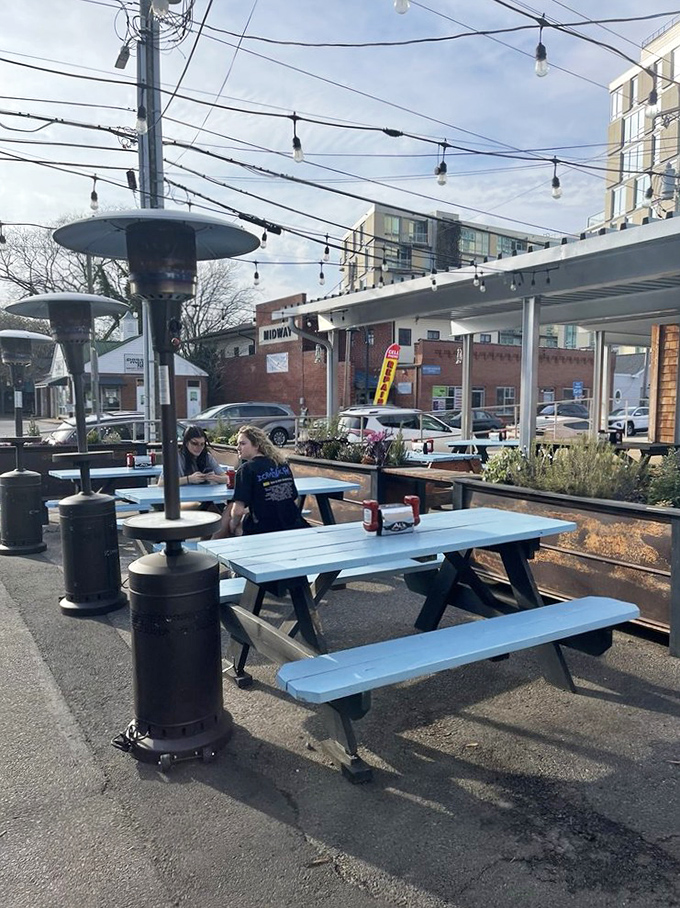 Blue picnic tables under string lights&mdash;the perfect stage for the burger drama about to unfold on your taste buds.